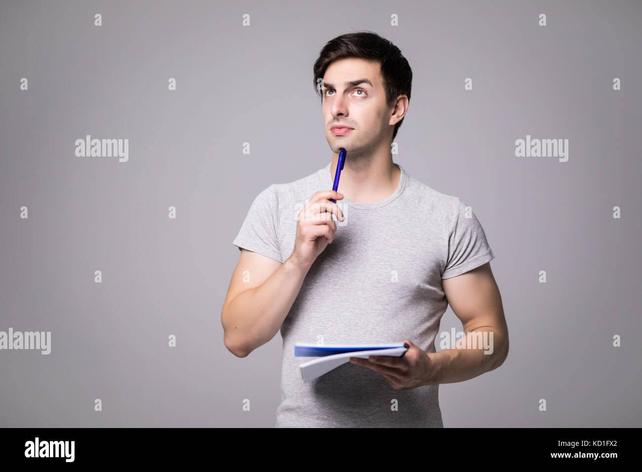 Young man holding opened black notebook in his hands Stock Photo - Alamy