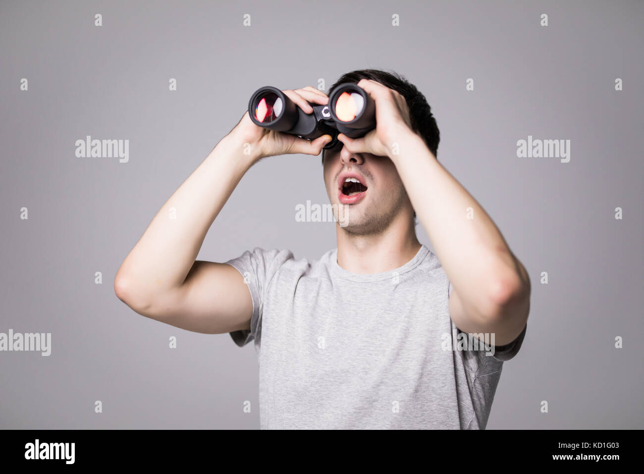 Young man with binoculars isolated on white background Stock Photo - Alamy