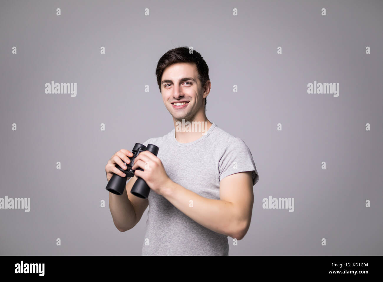 Young man with binoculars isolated on white background Stock Photo - Alamy