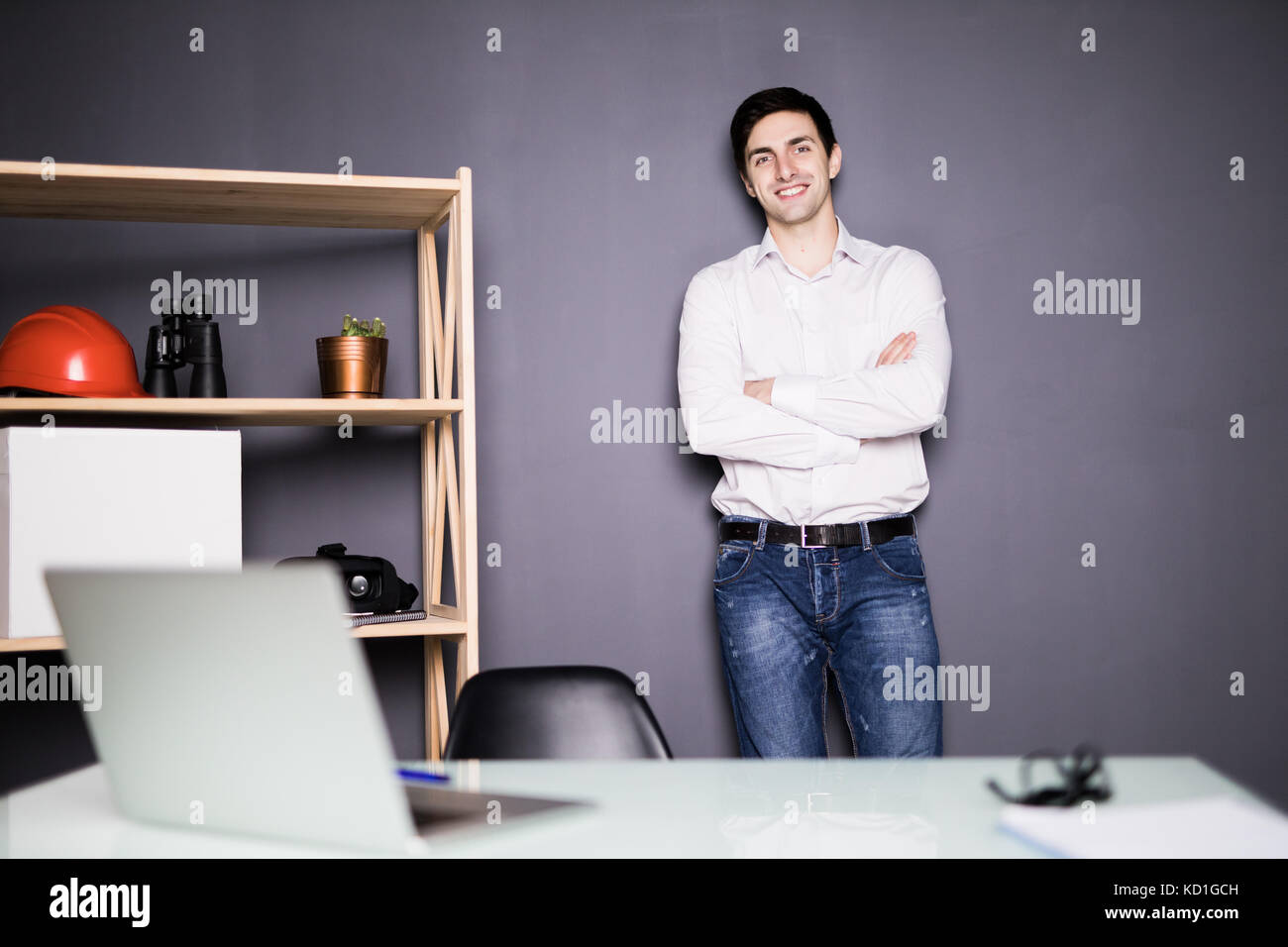 Happy businessman standing behind office desk, smiling Stock Photo - Alamy