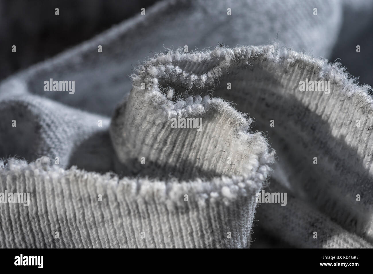 Close-up of the worn neckline of an old threadbare t-shirt - metaphor ...