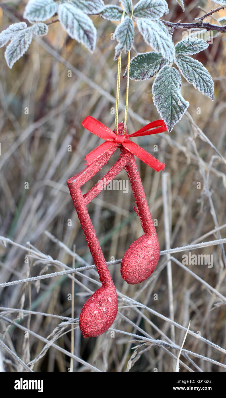 picture of a red shiny decorative christmas music notes Stock Photo - Alamy