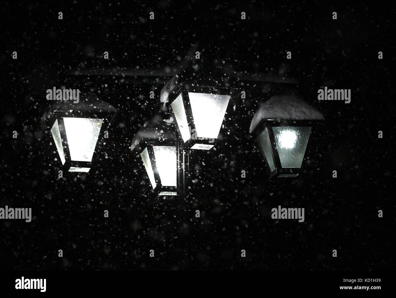 picture of a snowing january night.street chandelier lights Stock Photo ...
