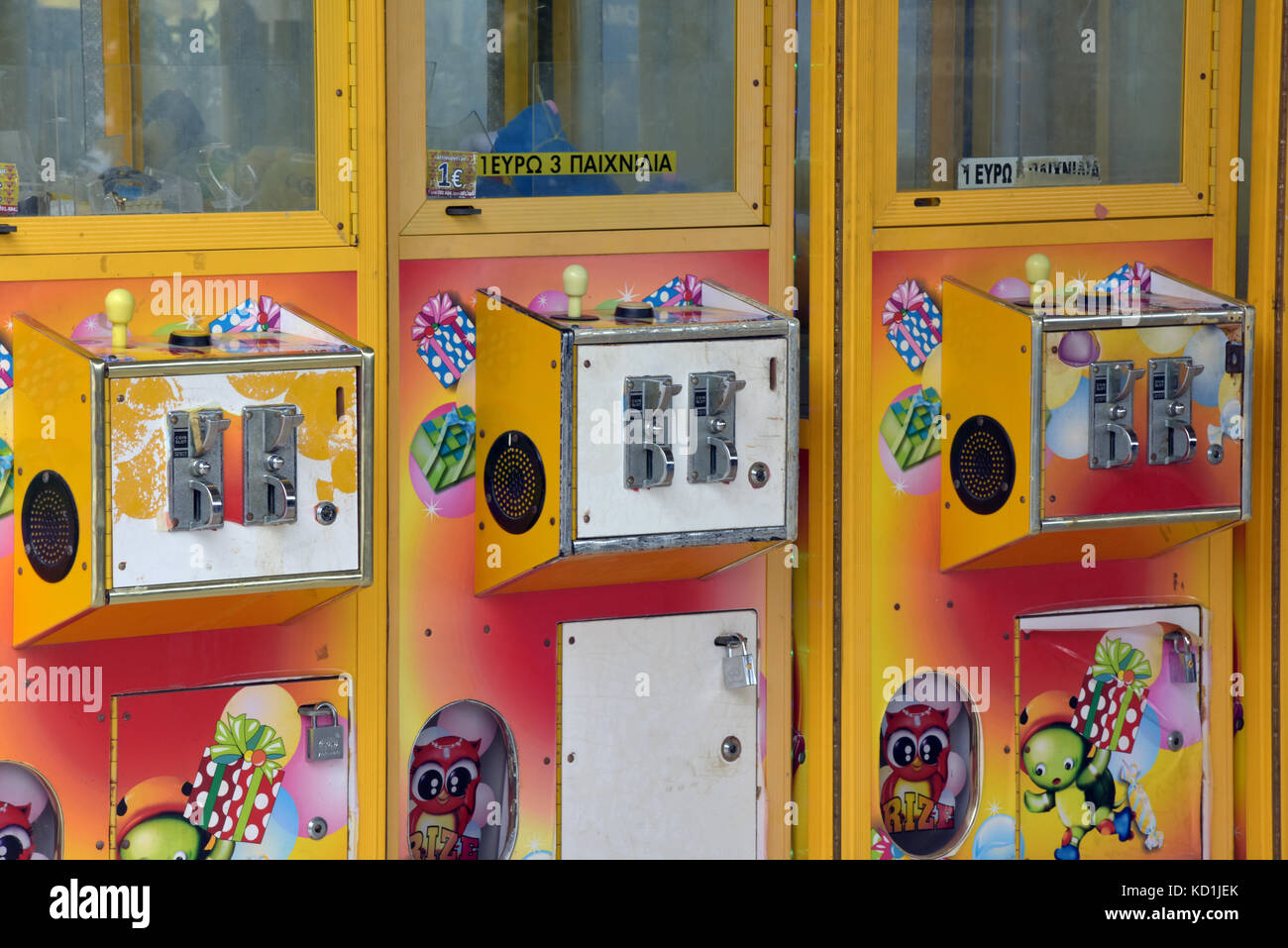 yellow or brightly painted coin mechanisms on amusement arcade machines ...