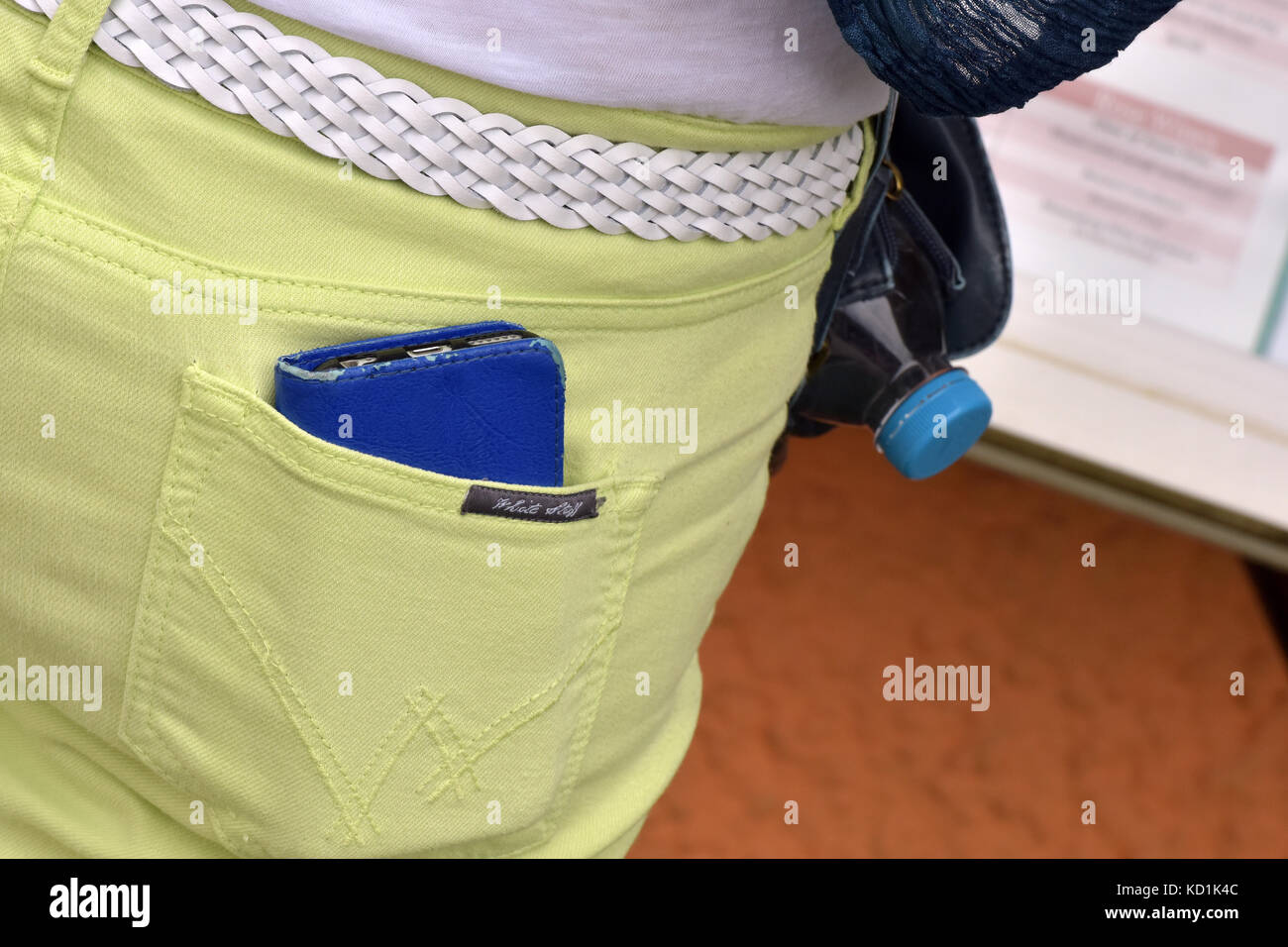 A mobile phone sticking out of a back pocket in a pair of coloured ...