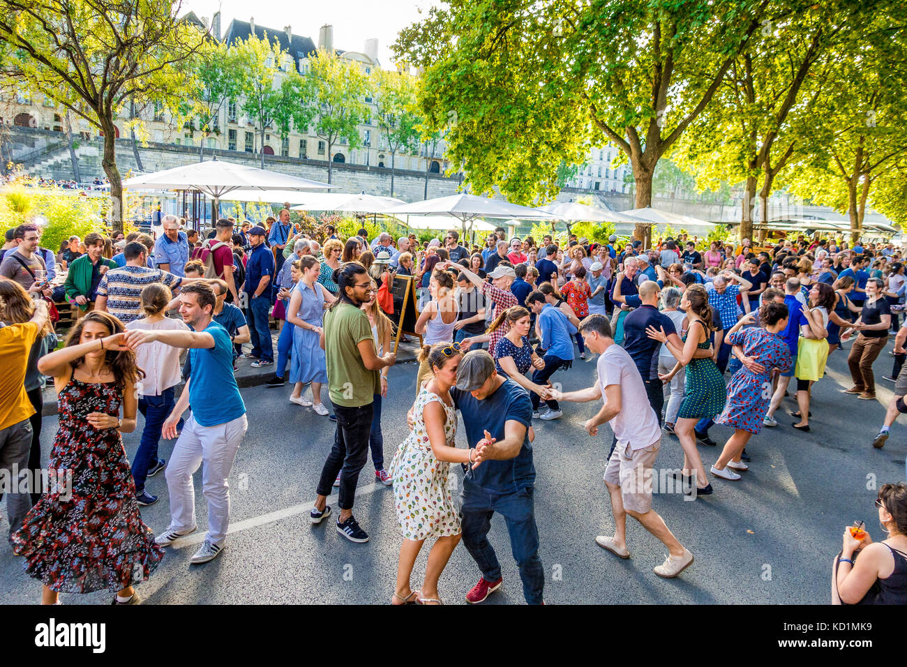 Crowds of people dancing by the Seine River as part of the Paris Plages ...