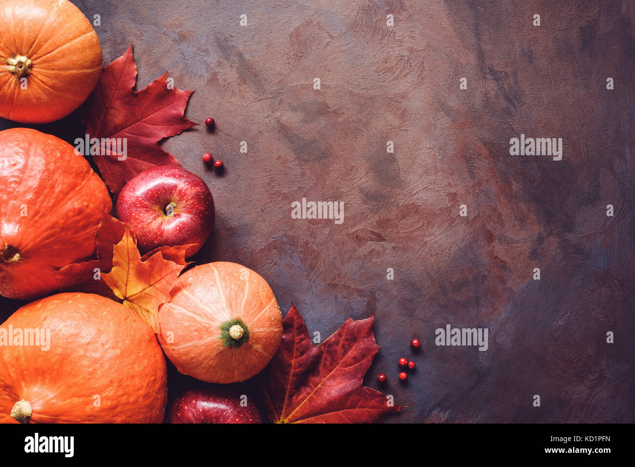 Autumn food background with pumpkins harvest, apples, red berries and ...