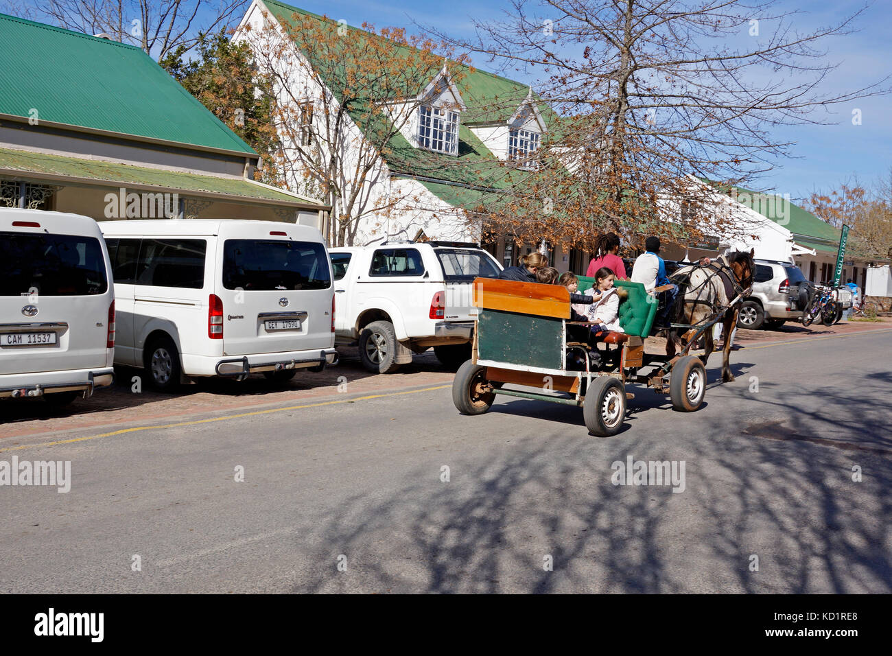 Visitors having a drive in a donkey cart in the main road of the ...