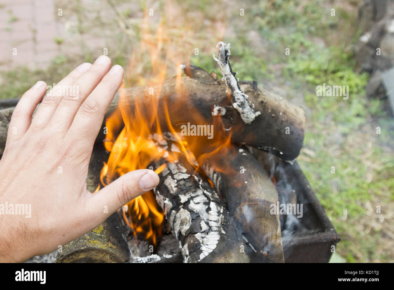 Homeless man warming hands near hi-res stock photography and images - Alamy