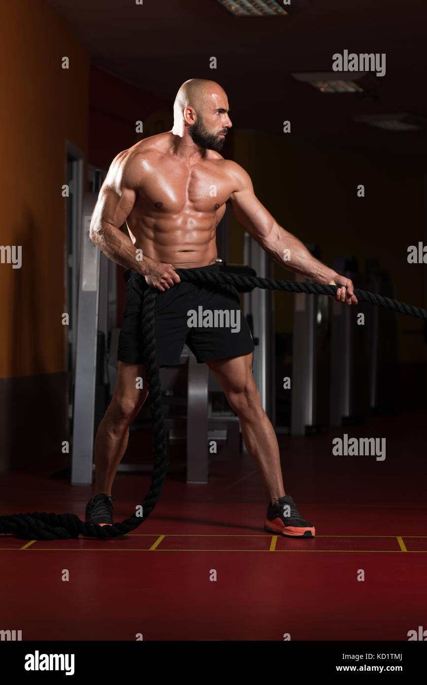 Man Battling Ropes At Gym Workout Exercise Stock Photo - Alamy