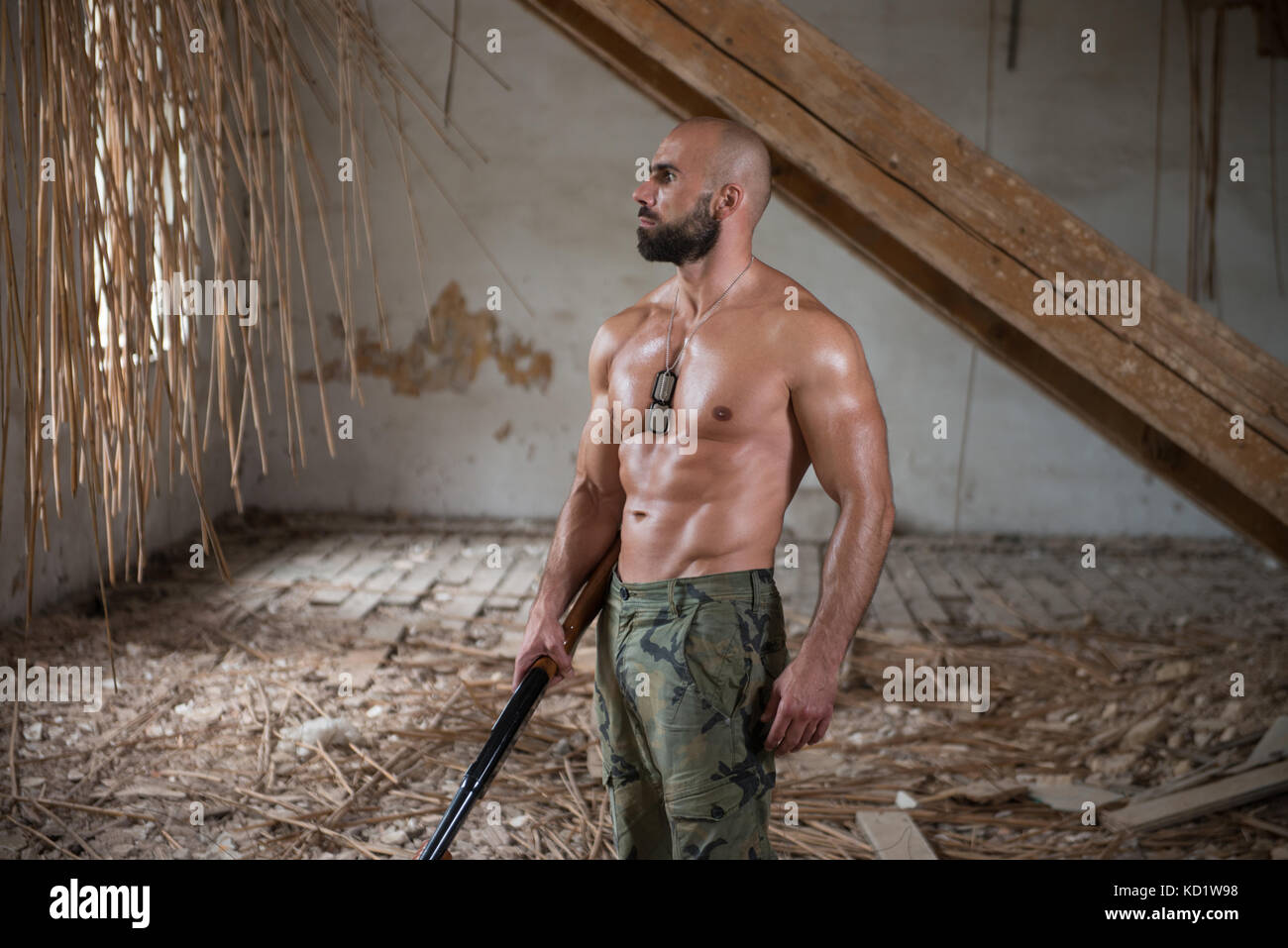 Action Hero Muscled Man Holding Machine Gun - Standing In Abandoned ...