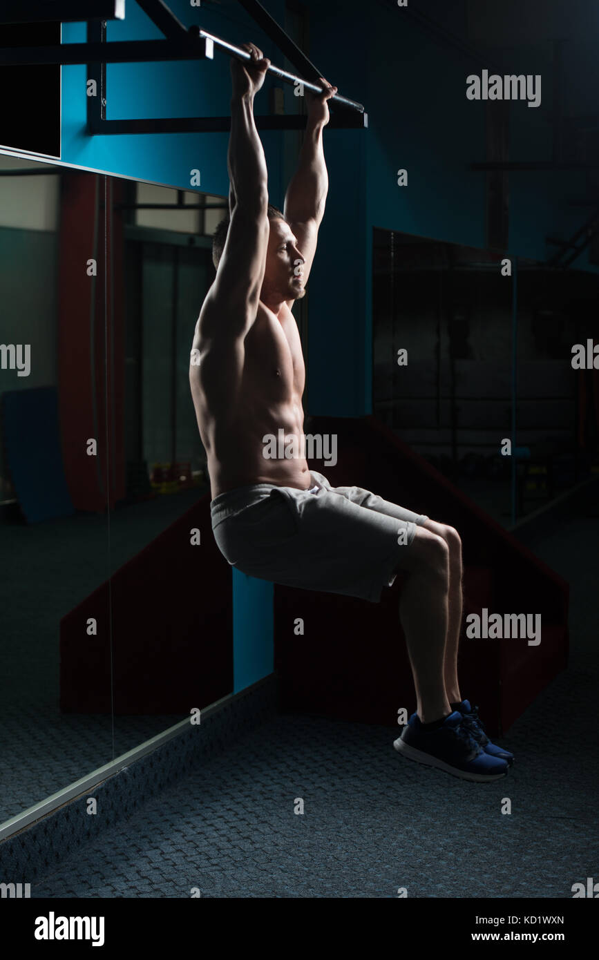 Athlete Performing Hanging Leg Raises Exercise - One Of The Most ...