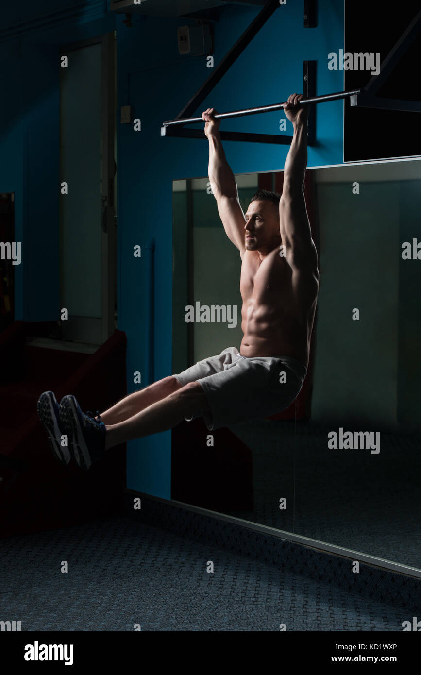 Athlete Performing Hanging Leg Raises Exercise - One Of The Most ...