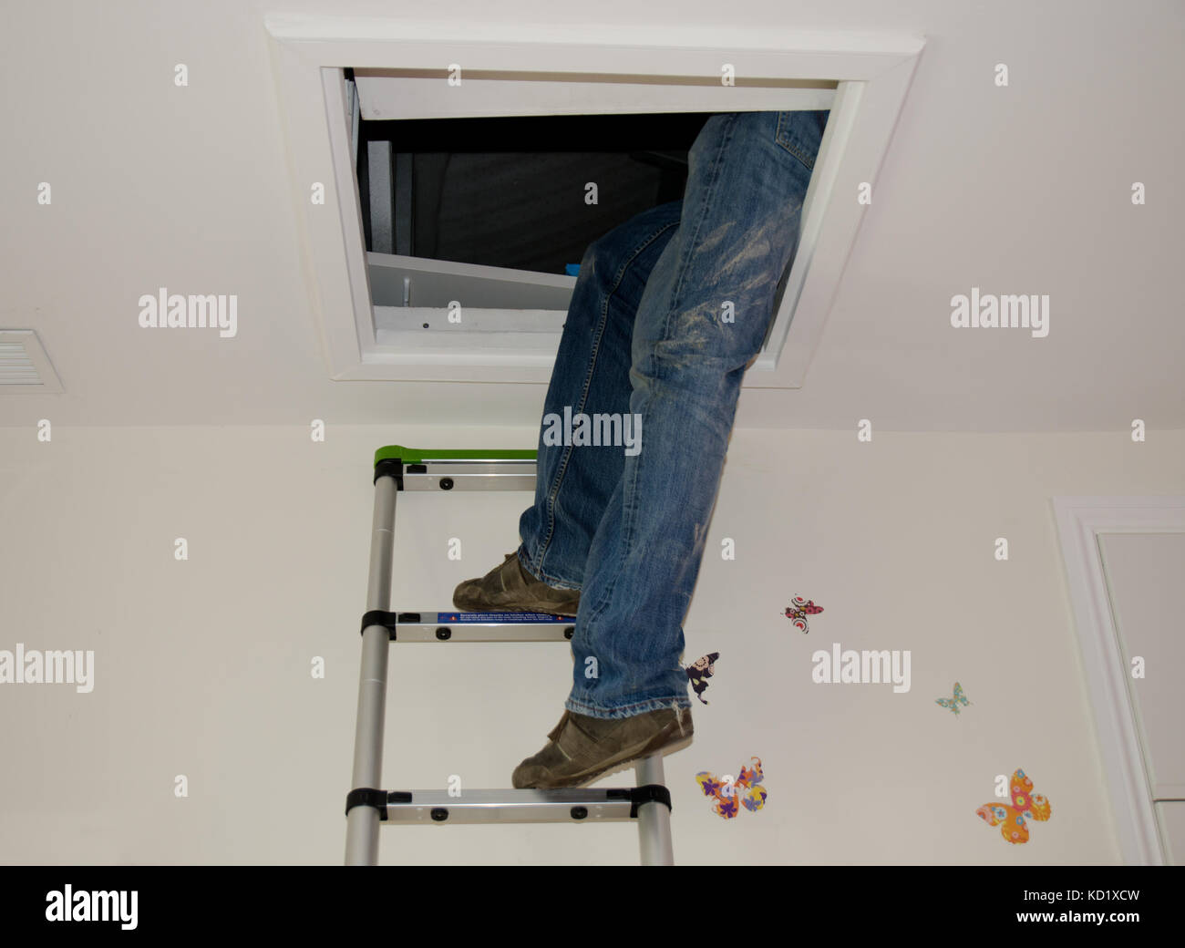 Climbing into the loft Stock Photo - Alamy