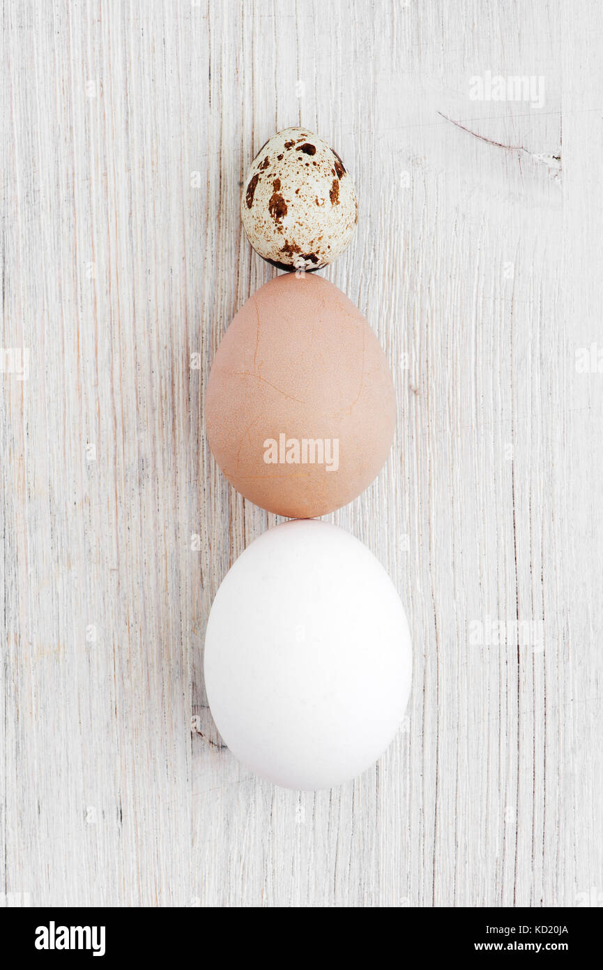 Various eggs on the white wooden table Stock Photo - Alamy