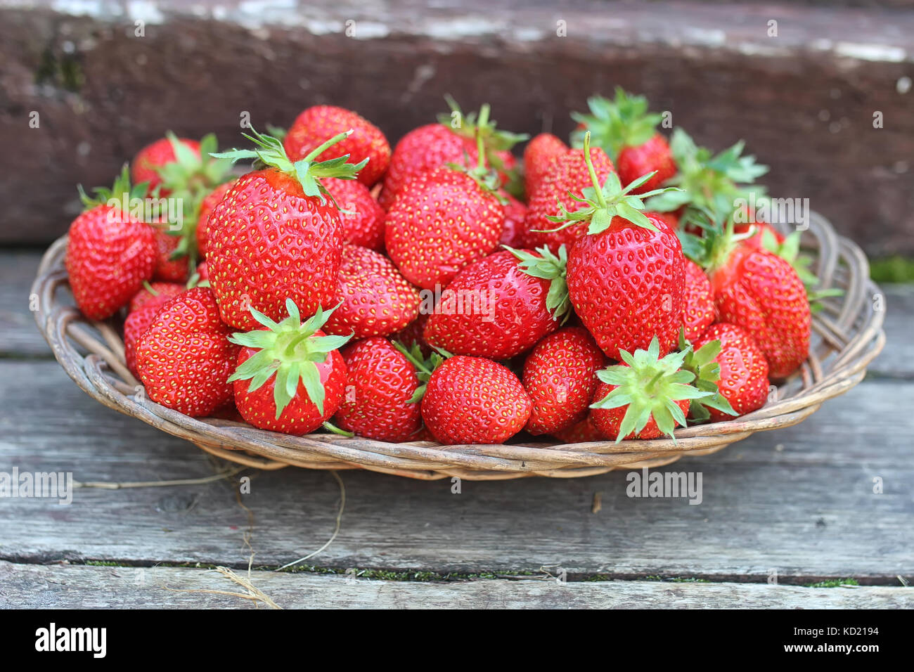 Strawberry on rustic wooden background Stock Photo - Alamy