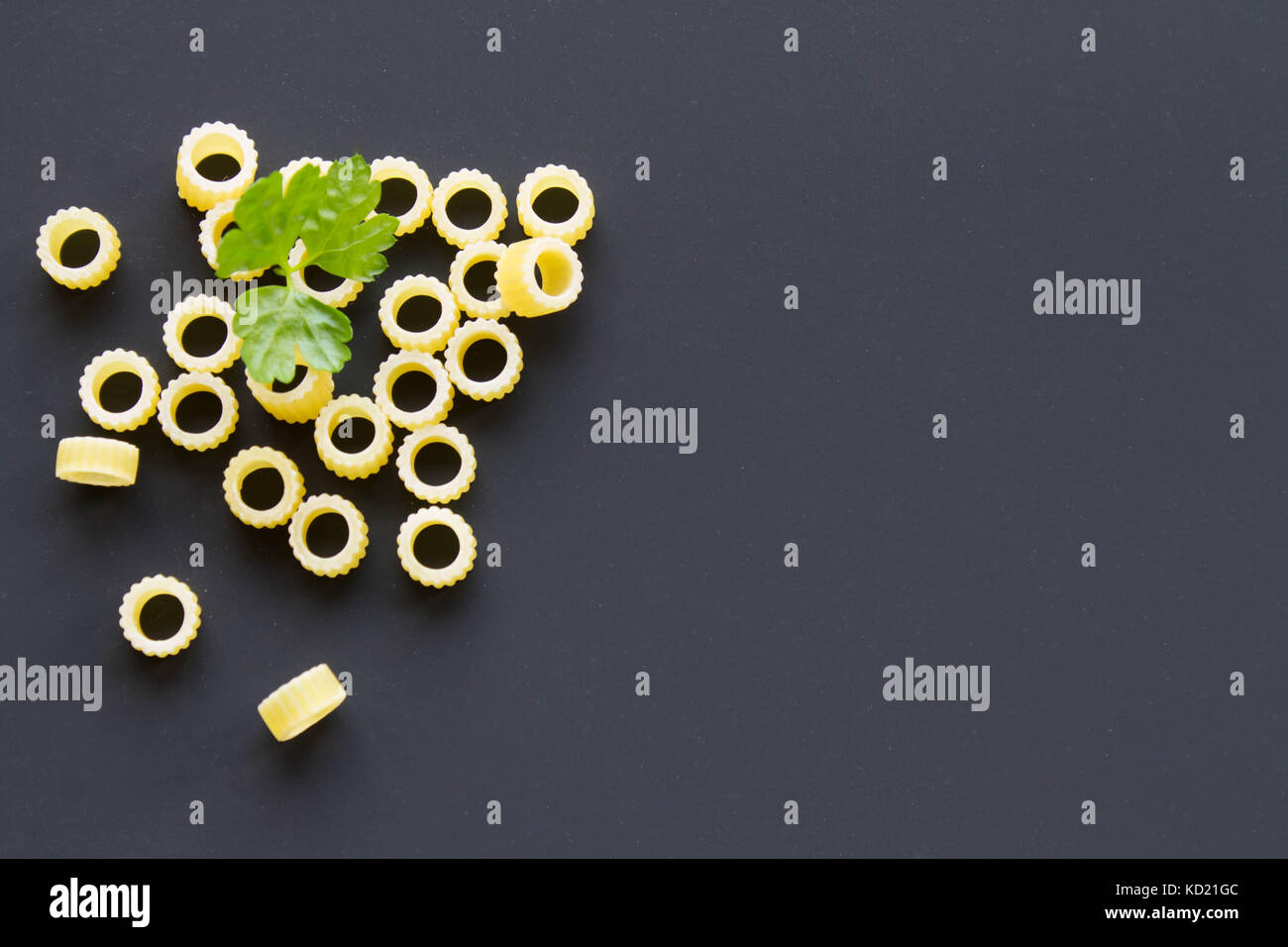 Pasta rings on a black background Stock Photo - Alamy