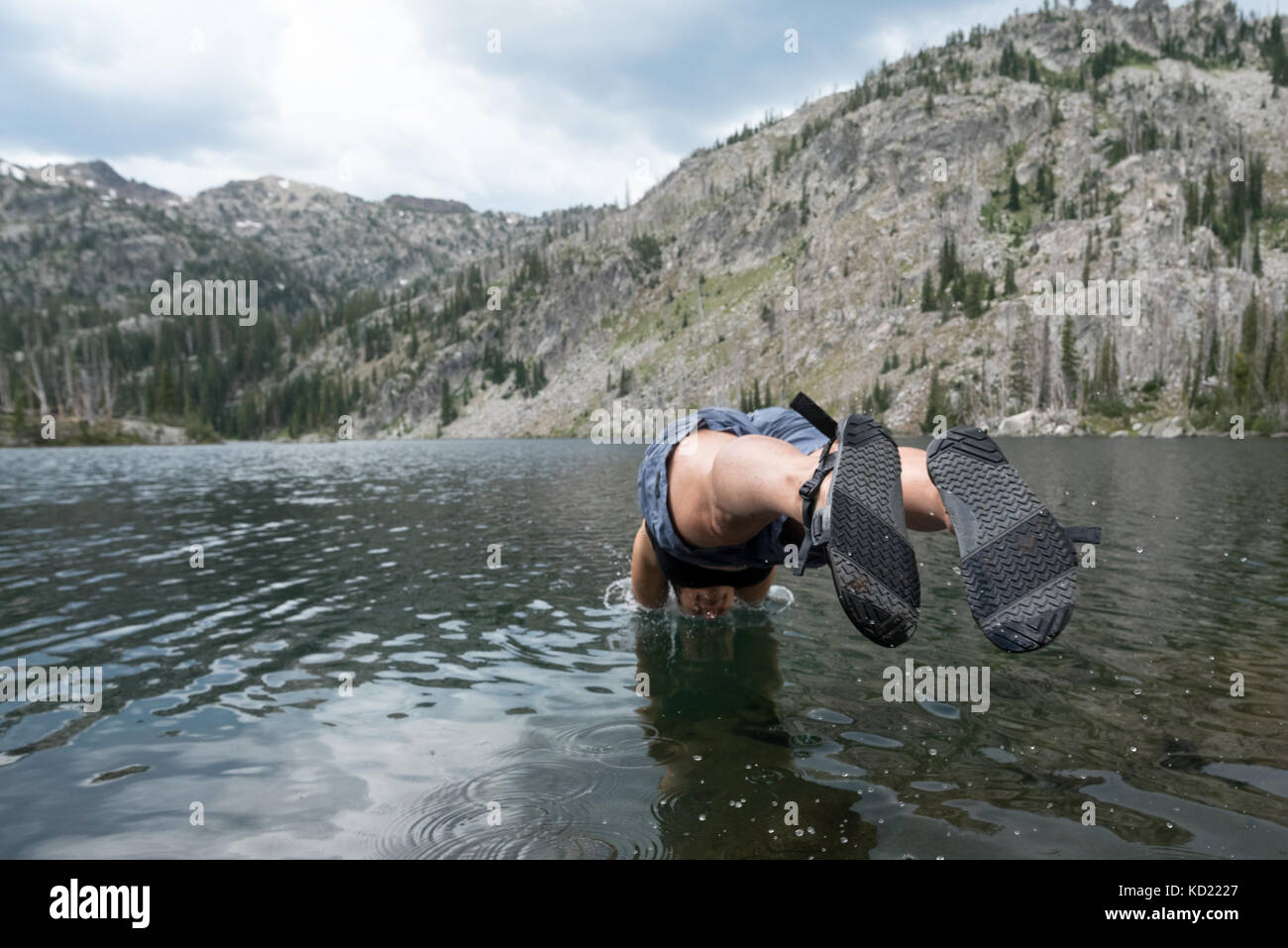 Woman diving into a lake in Oregon's Wallowa Mountains.d Stock Photo ...