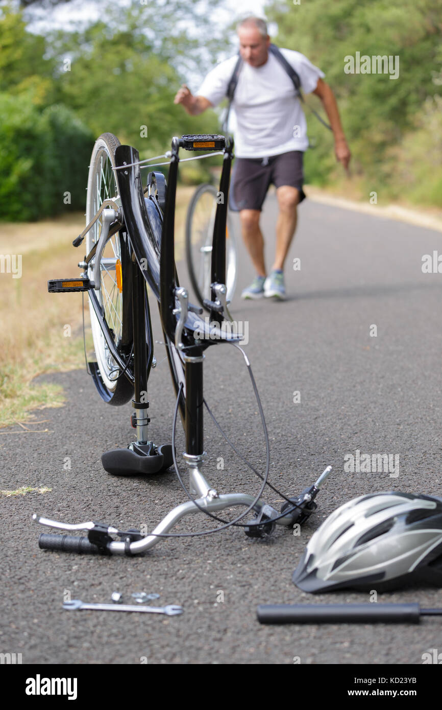 cyclist ready to carry his broken bike uphill Stock Photo - Alamy