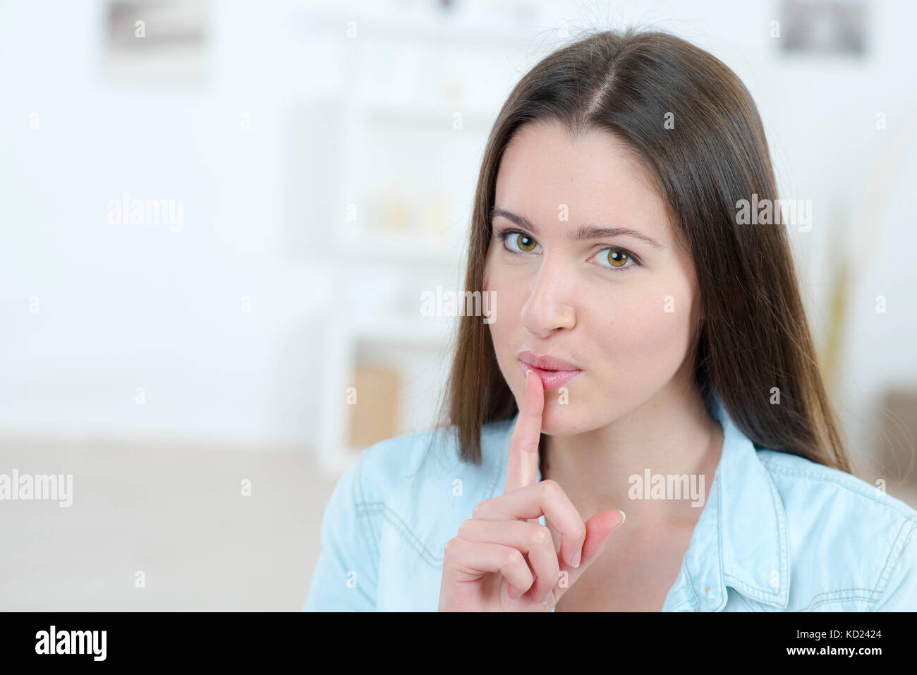 beautiful young woman asking for silence Stock Photo - Alamy