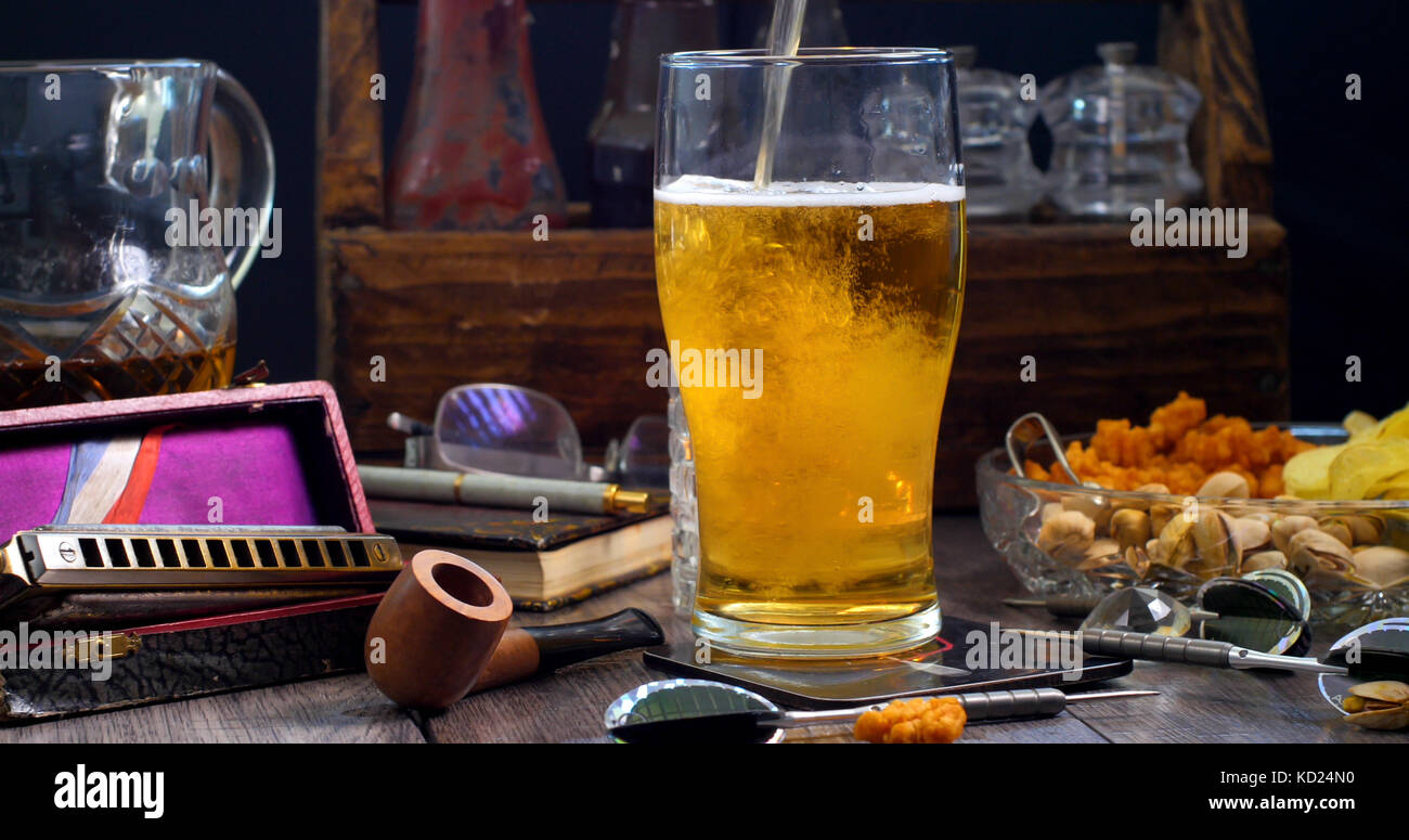 Pouring lager beer on a pint glass in a pub Stock Photo - Alamy