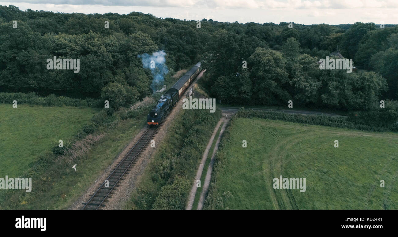 Aerial view of an old fashioned steam train crossing the English ...