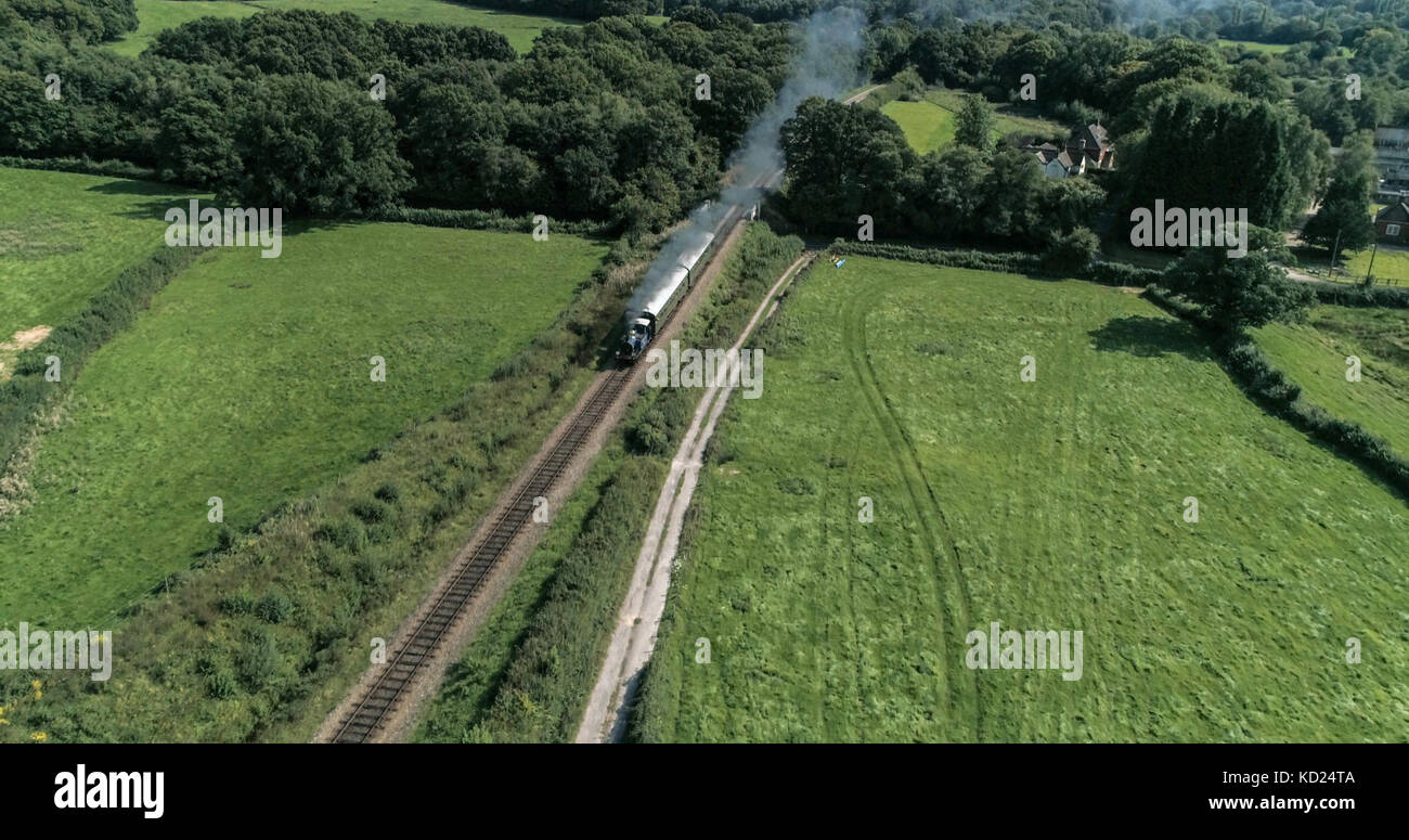 Aerial view of an old fashioned steam train crossing the English ...