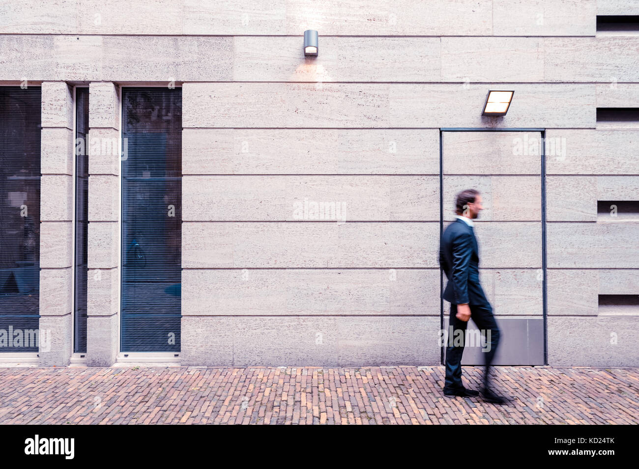 Model Ralph Pieters walking in front of a wall in a street fashion ...