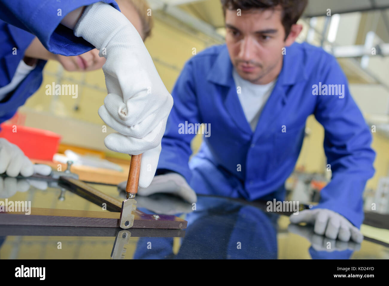 Female worker cutting glass Stock Photo - Alamy