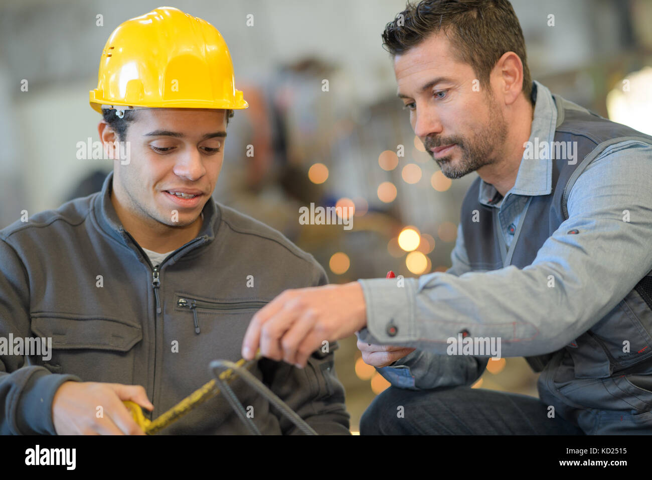 boss and worker in yellow hard hat at warehouse Stock Photo - Alamy