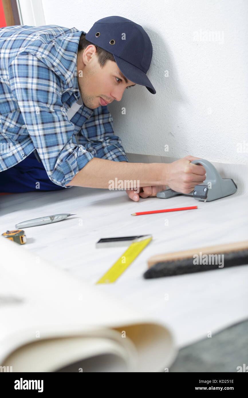 young technician installing floor at construction site Stock Photo - Alamy