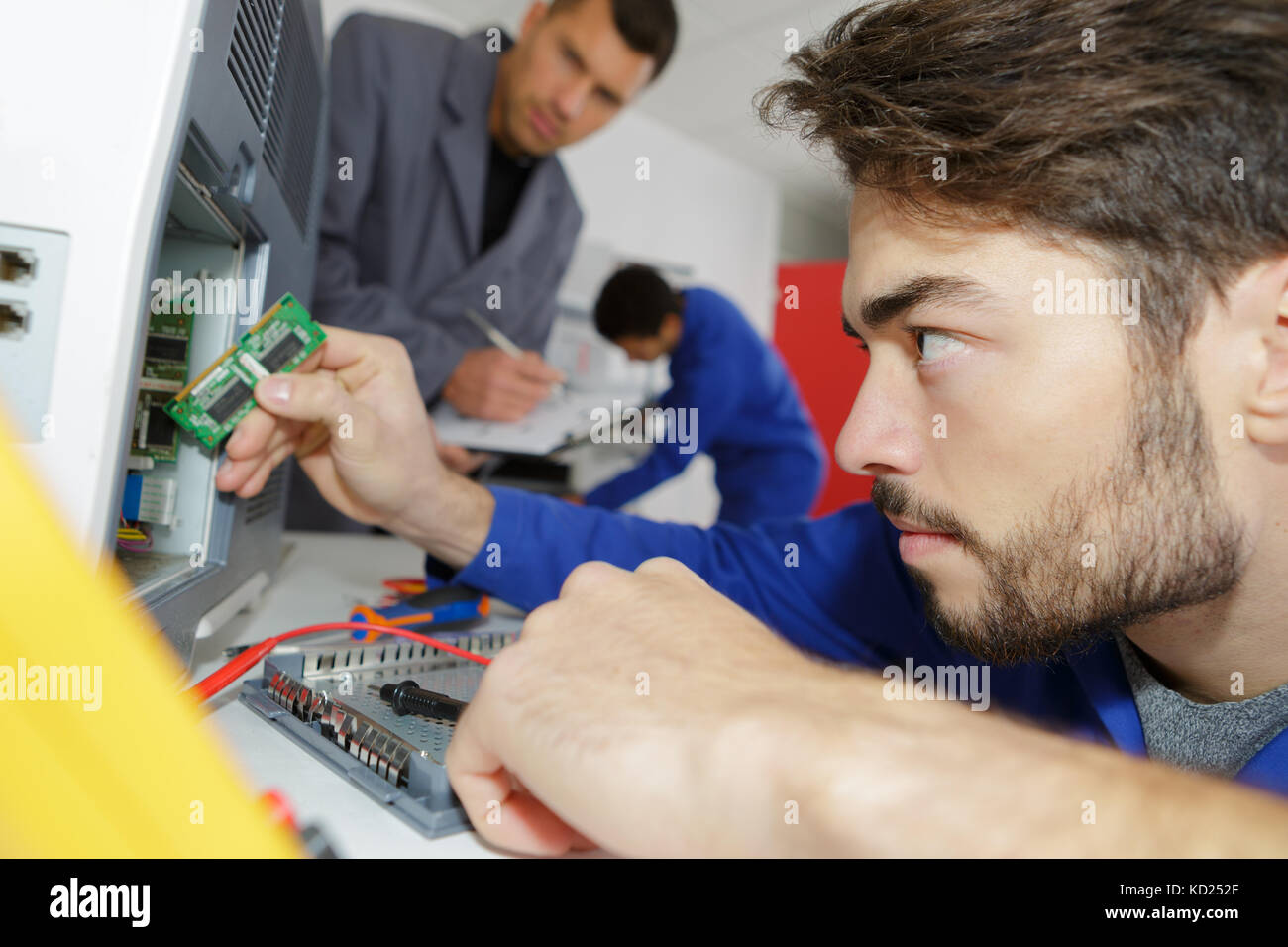 male checking electronic devices at workshop Stock Photo - Alamy