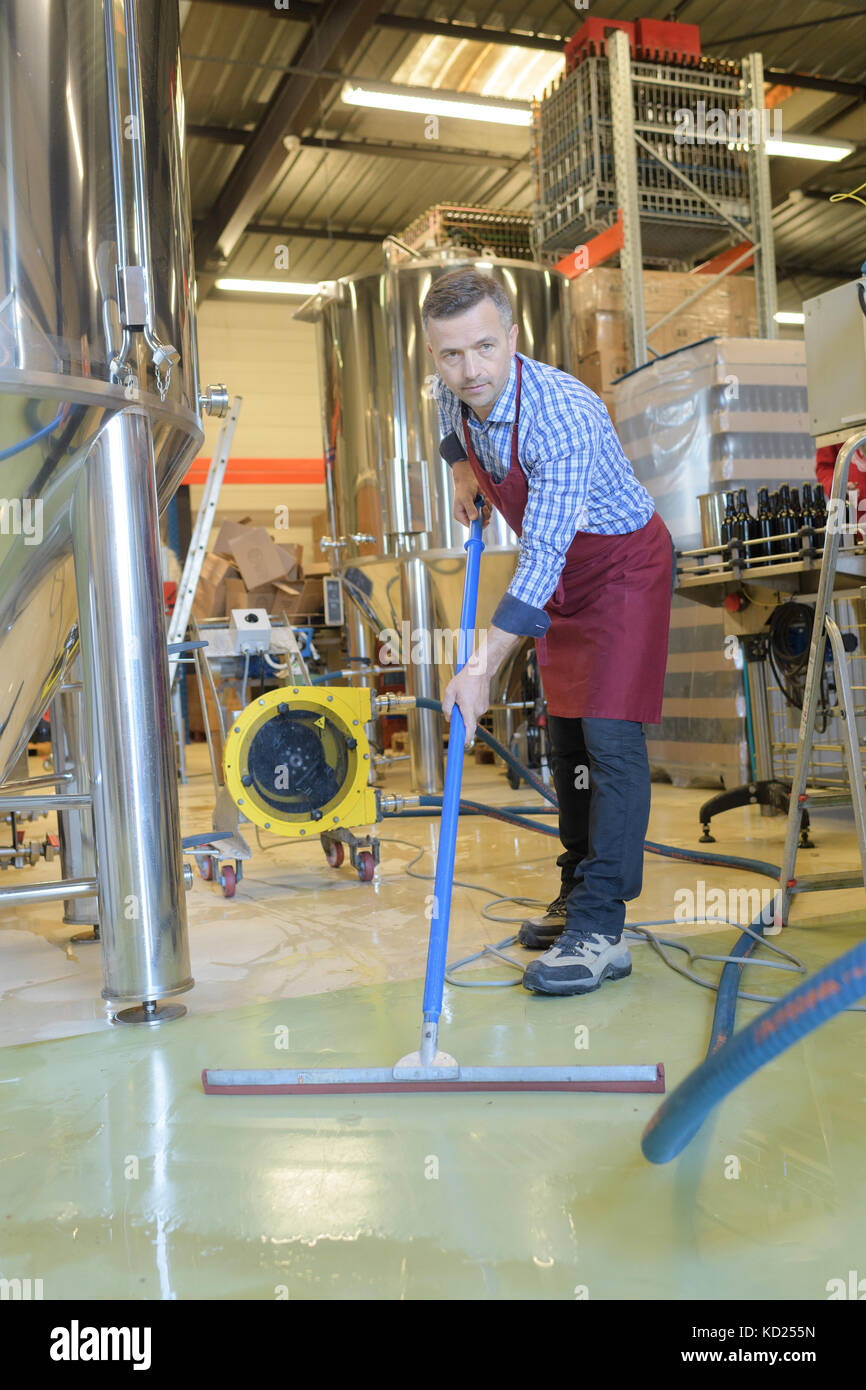 factory worker cleaning floor Stock Photo - Alamy