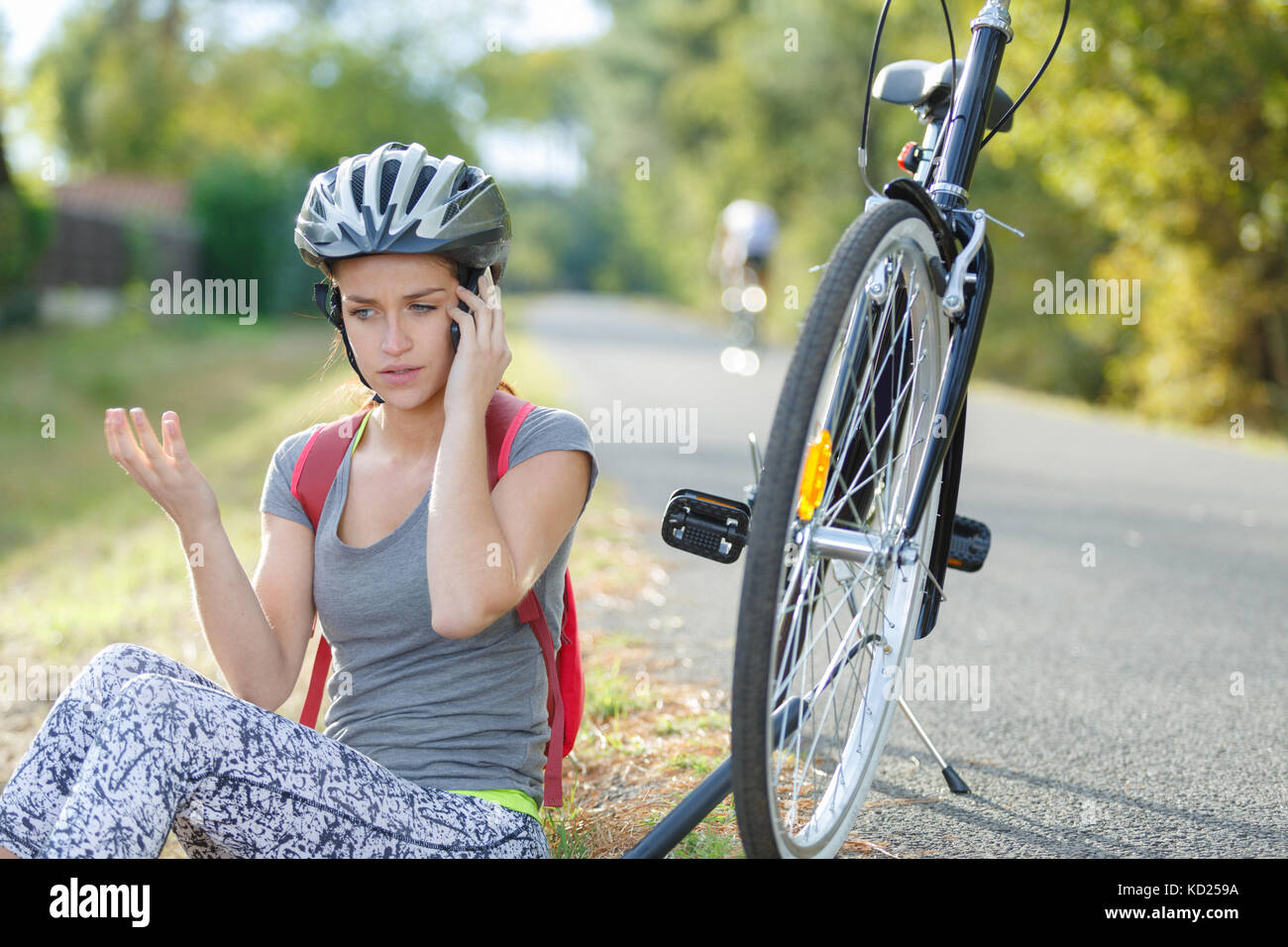 young woman is having a problem with her bike Stock Photo - Alamy