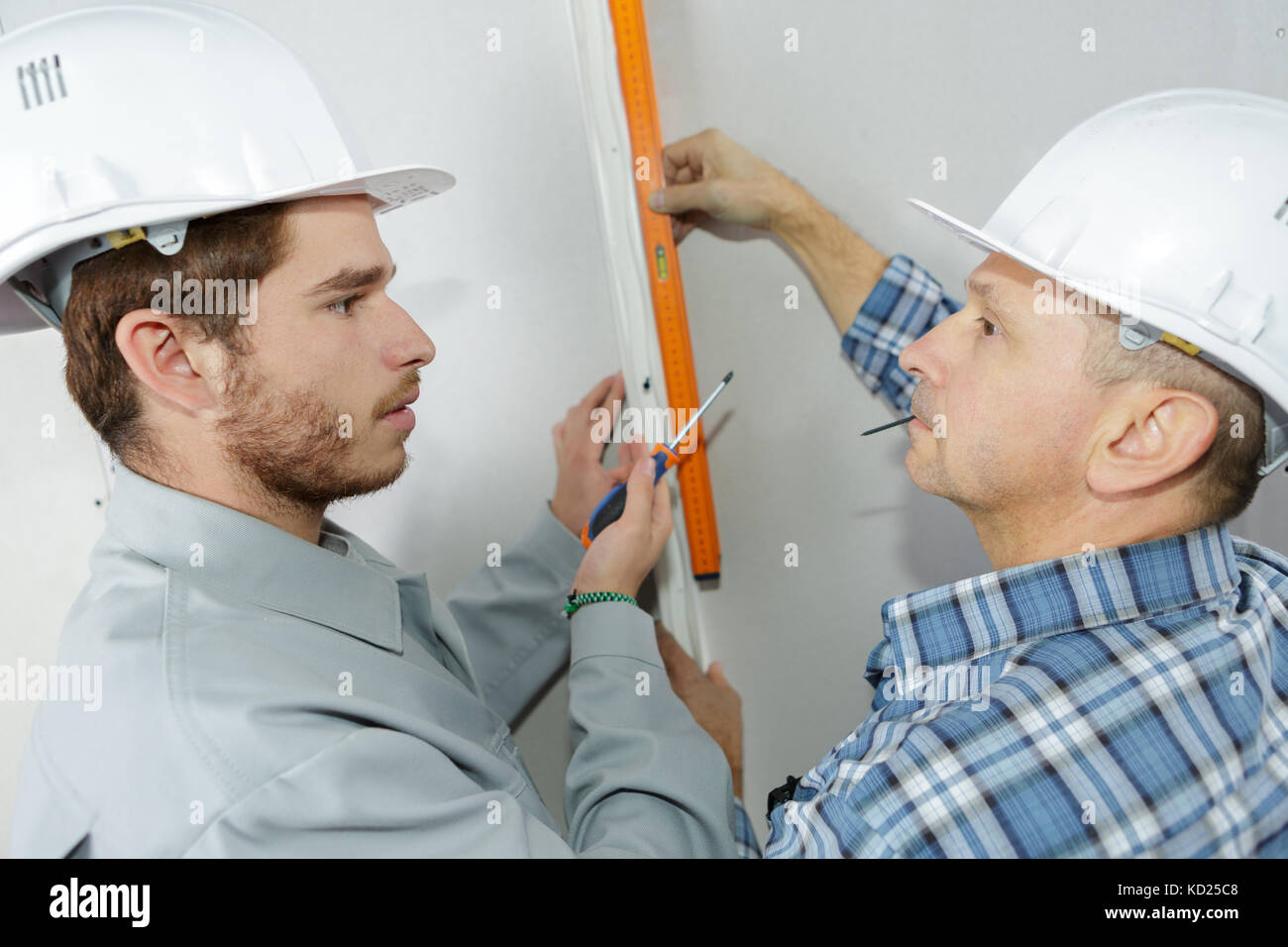 builder men with level Stock Photo - Alamy