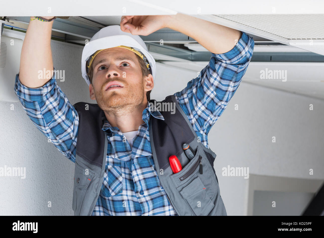 electrical worker wiring in ceiling Stock Photo - Alamy