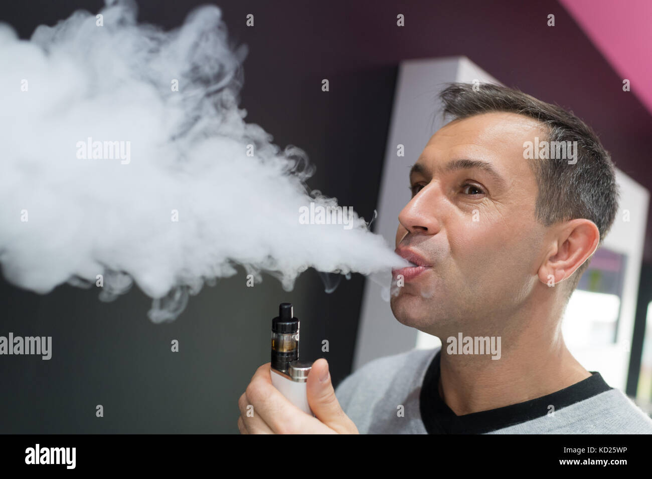smoking man and smoking electric cigarette Stock Photo - Alamy