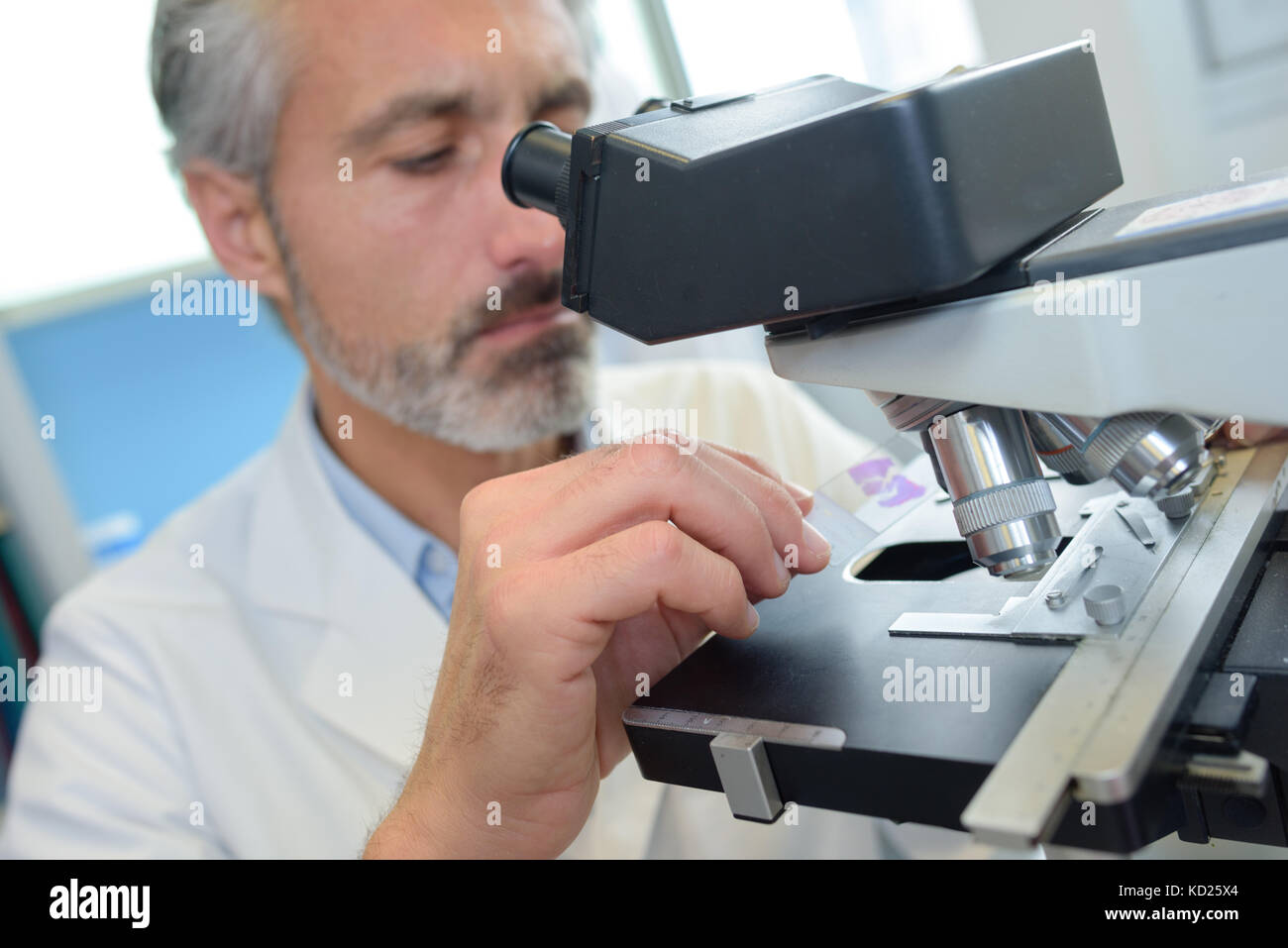 Man using microscope Stock Photo - Alamy