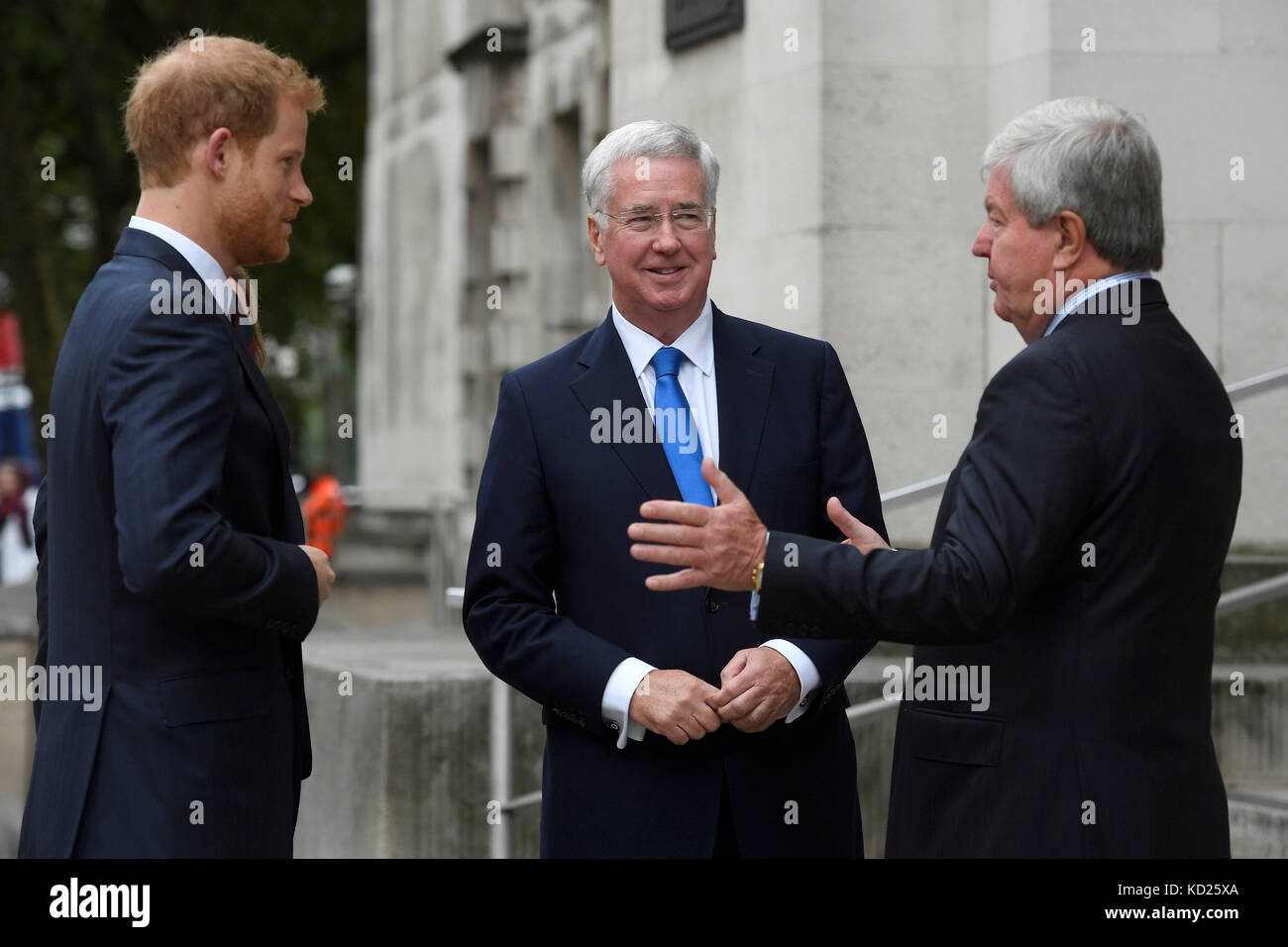Prince Harry (left) is greeted by Defence Secretary, Michael Fallon and ...