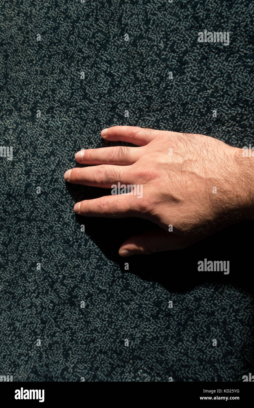 CLose up of a man's hand on the floor Stock Photo - Alamy