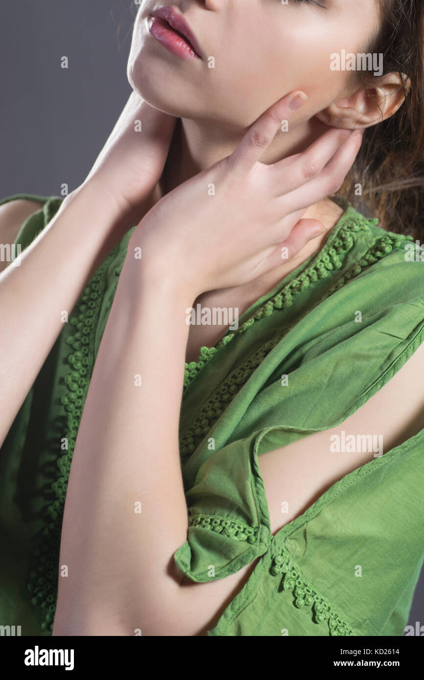 Close up of a young woman hands touching neck Stock Photo - Alamy