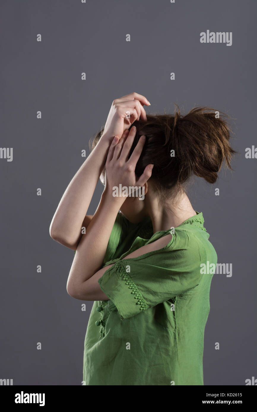 Young woman hiding face in fear Stock Photo - Alamy