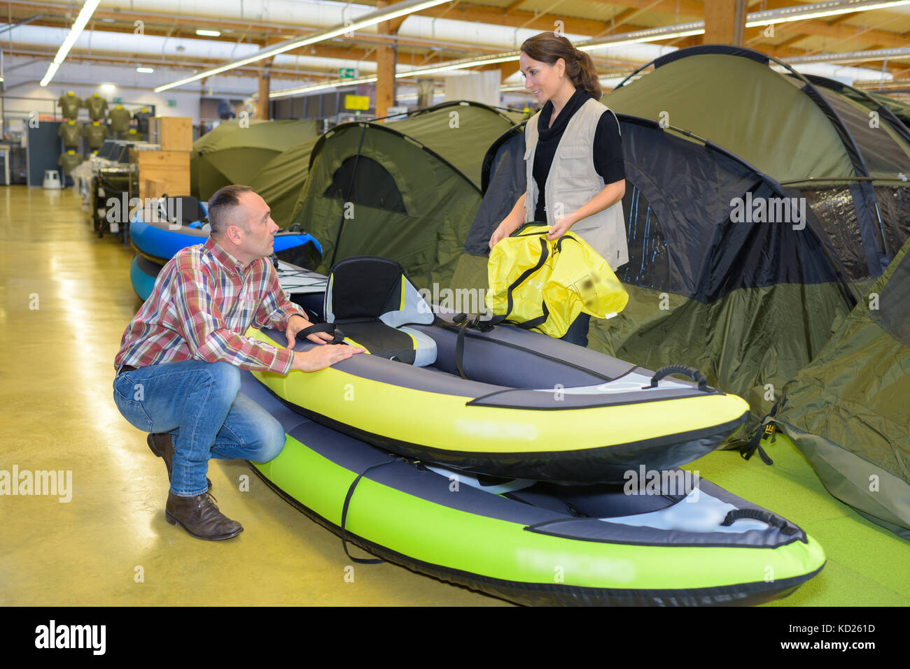 Man looking at inflatable dingys in a shop Stock Photo - Alamy