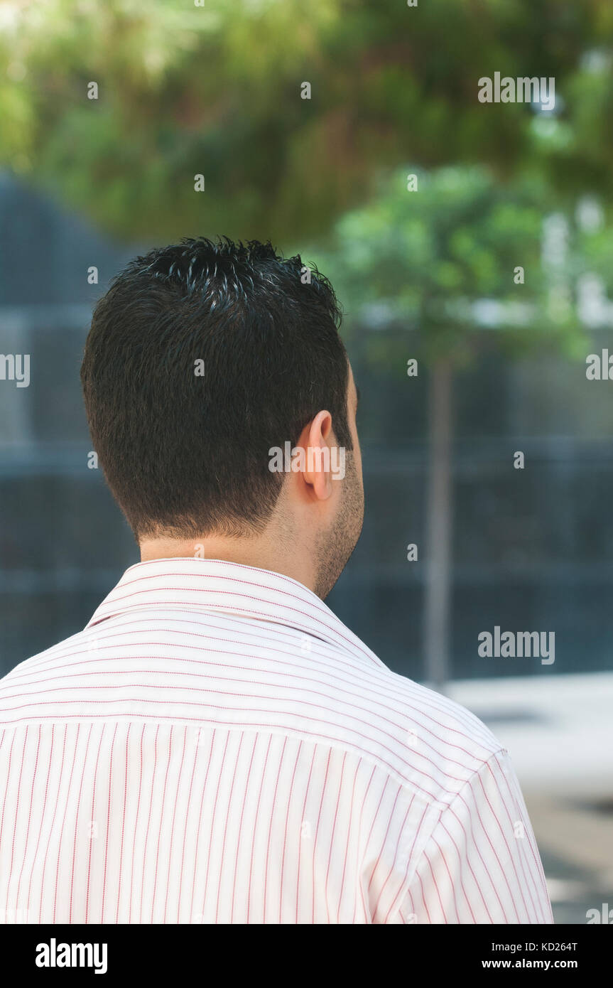 Rear view of a man standing outdoors Stock Photo - Alamy