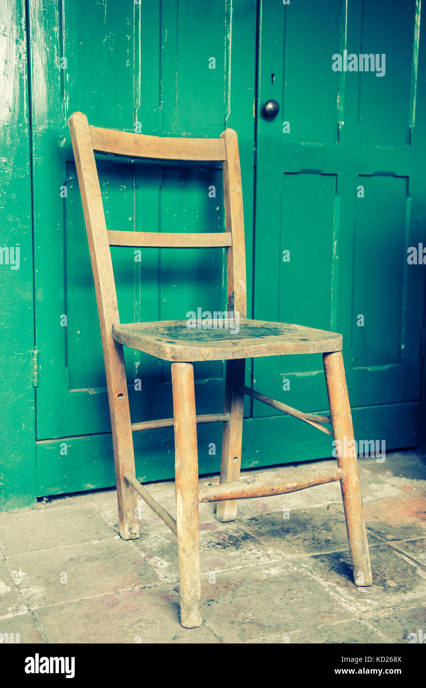 Old wooden chair by the door Stock Photo - Alamy