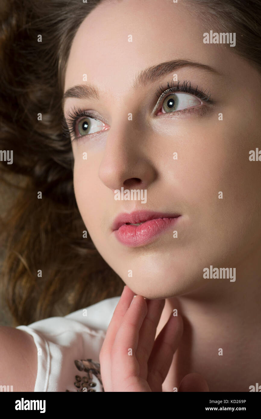 Beautiful young woman looking away daydreaming Stock Photo - Alamy