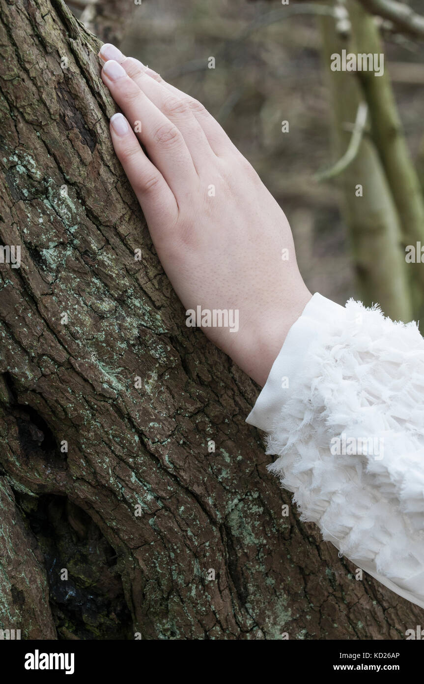 Close up of a woman's hand leaning on a tree ] Stock Photo - Alamy