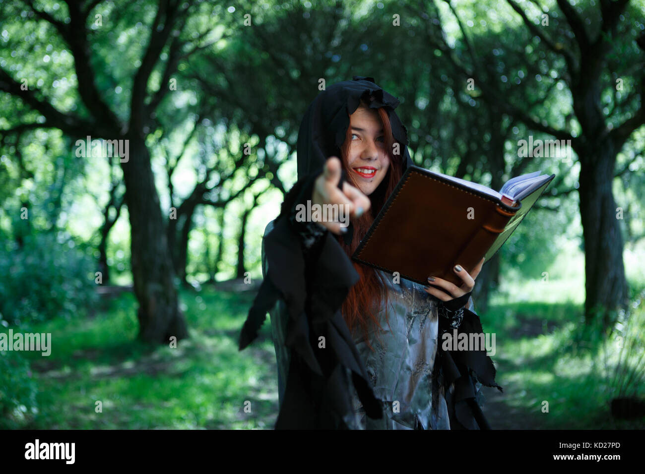 Smiling witch with pointing finger Stock Photo - Alamy