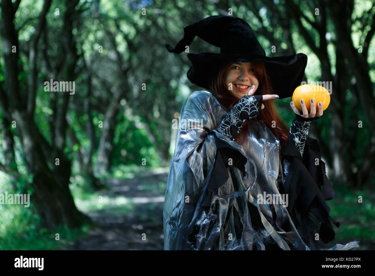 Photo of witch pointing finger at pumpkin Stock Photo - Alamy