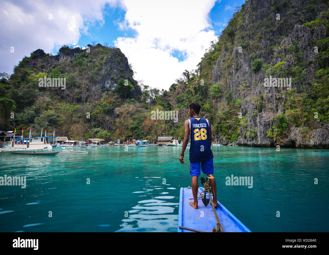Coron, Philippines - Apr 9, 2017. A man standing on boat in Coron ...